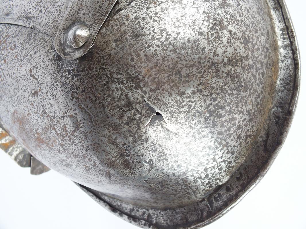 An Italian close-helmet of Savoyard form, the two-piece skull with ...
