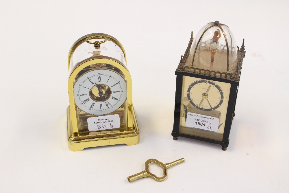 An Estyma musical clock (1950s) and a brass plated 'Du Chateau ...
