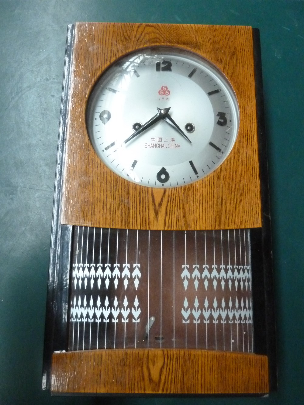 A Chinese oak cased 8 day hanging clock, by 555 for Shanghai, China, 48cm