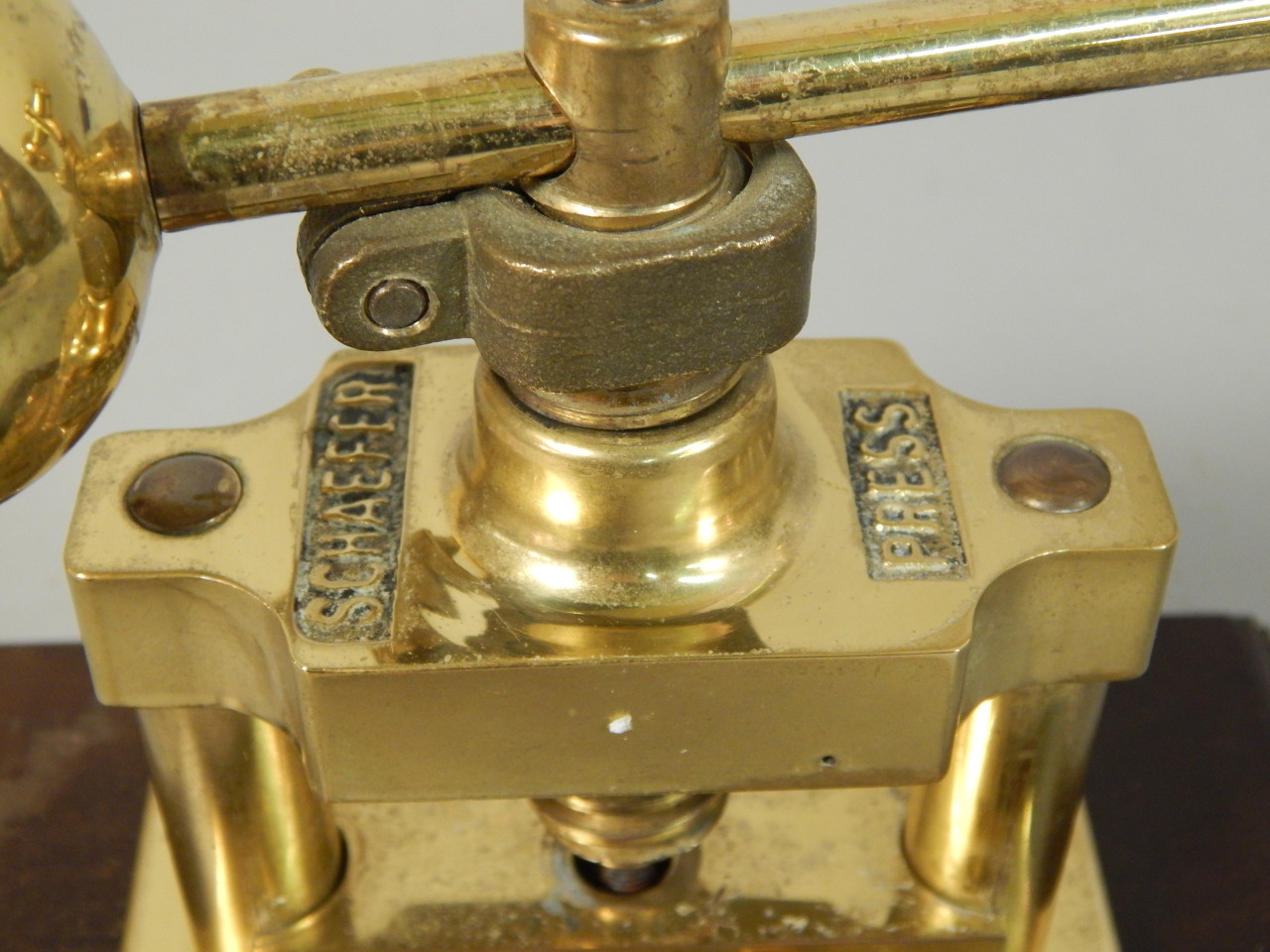 A brass and mahogany Schaefer press.