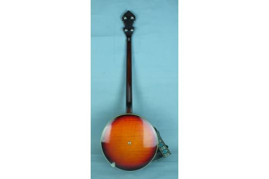 A four-string banjo with 'Remo Weather King' banjo head, 95cm overall ...