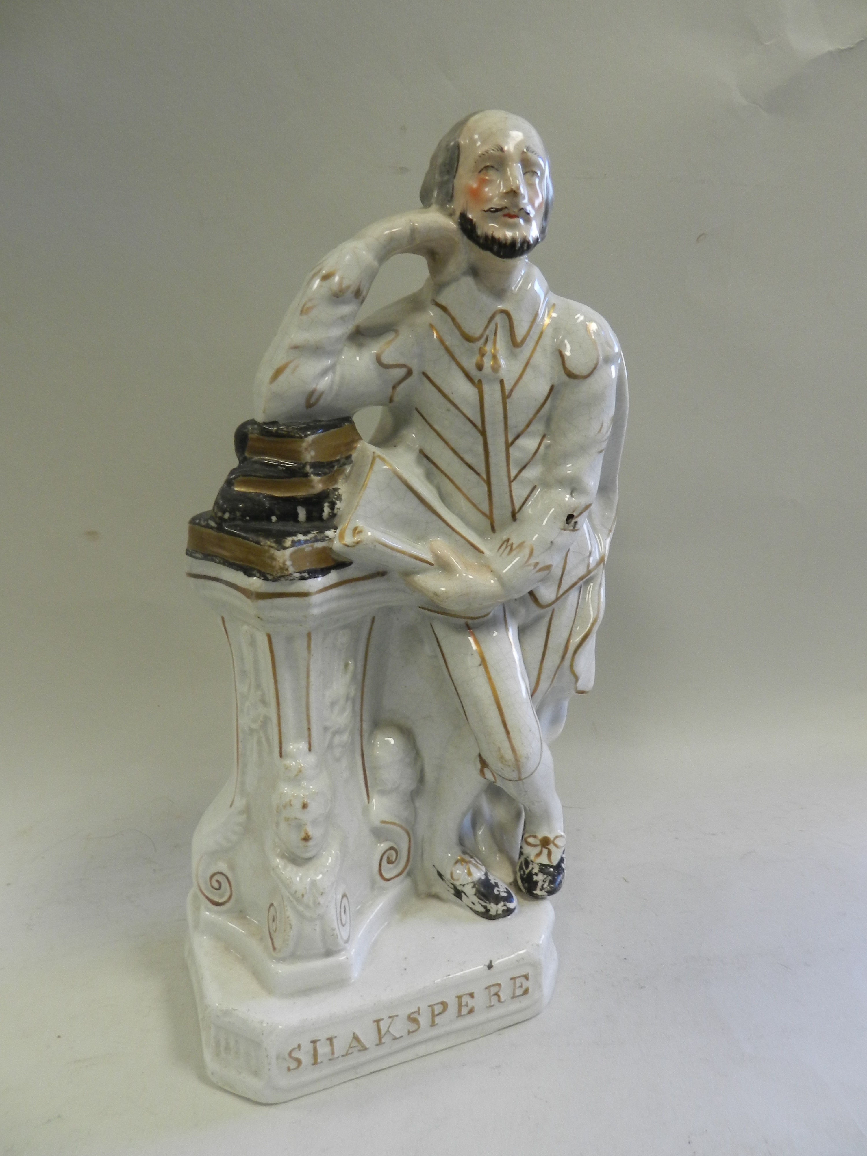 A Staffordshire 'Shakespeare' figure, modelled leaning on a stack of ...