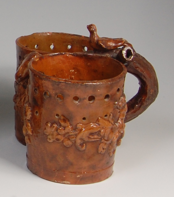 An Edward Bingham Castle Hedingham Pottery double puzzle mug, the ...