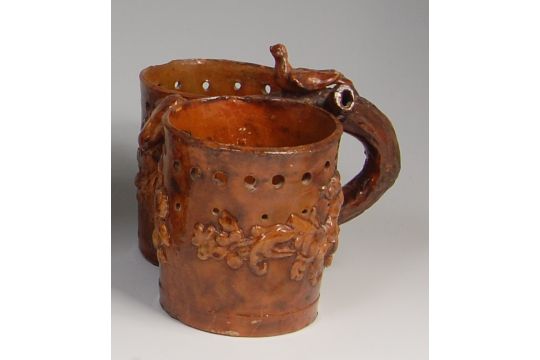 An Edward Bingham Castle Hedingham Pottery double puzzle mug, the ...