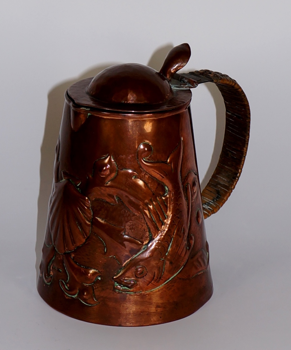 A Newlyn copper lidded jug with hammer textured domed cover and thumb ...