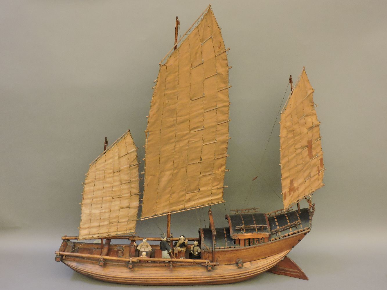 A model of a Chinese junk, circa 1930s, with three sails and a crew ...
