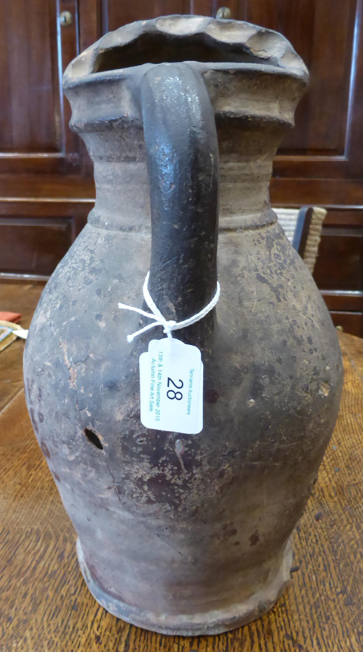 A Terracotta Watering Can, 16th century, of baluster form with pierced ...