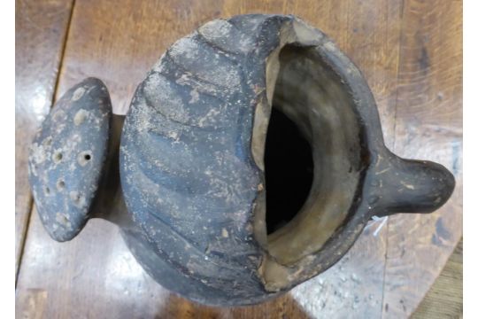 A Terracotta Watering Can, 16th century, of baluster form with pierced ...