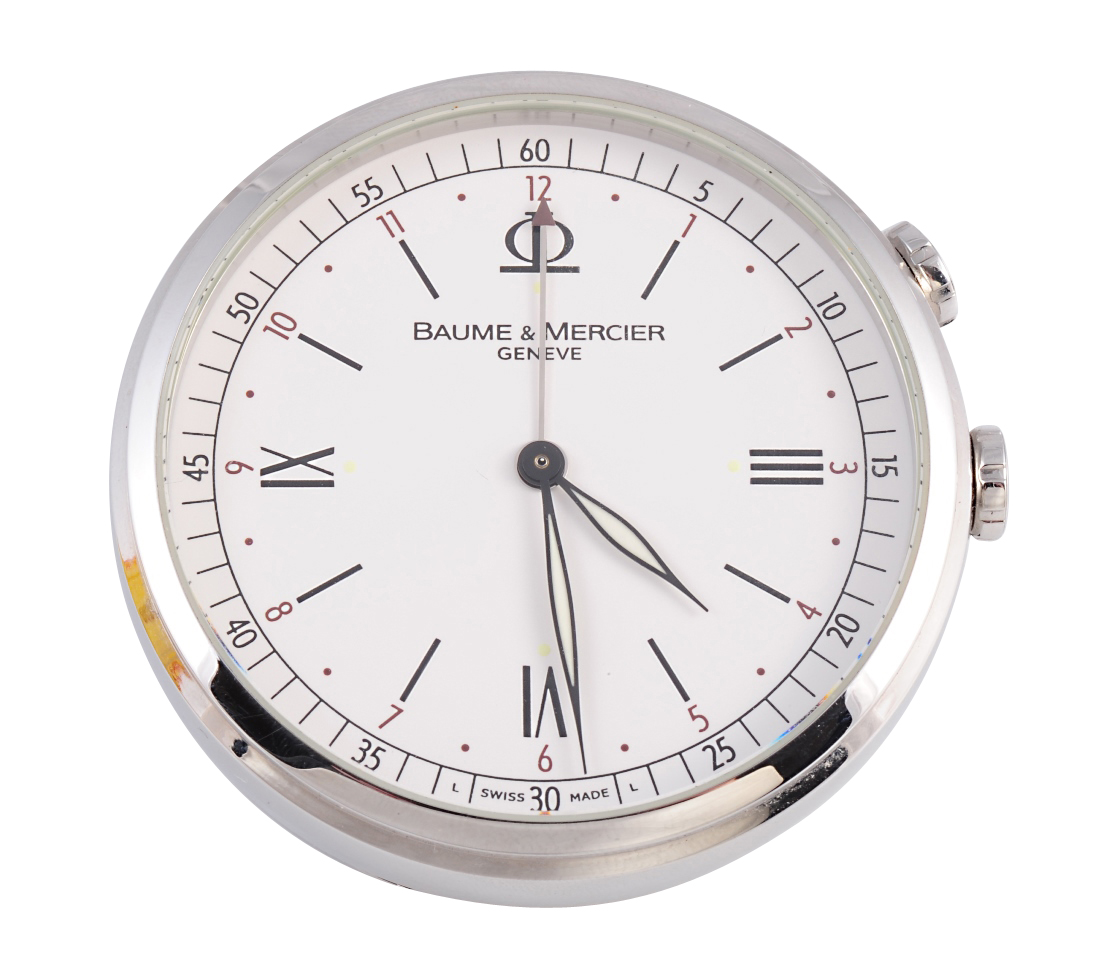 A stainless steel travel clock, signed Baume & Mercier, Geneve, the ...