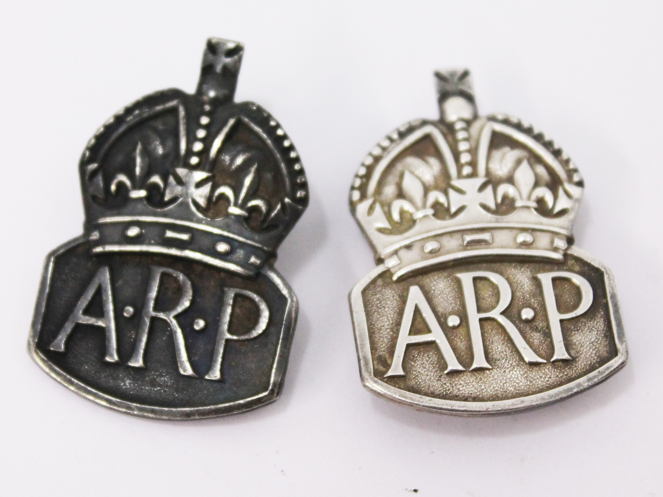Two hallmarked silver ARP badges