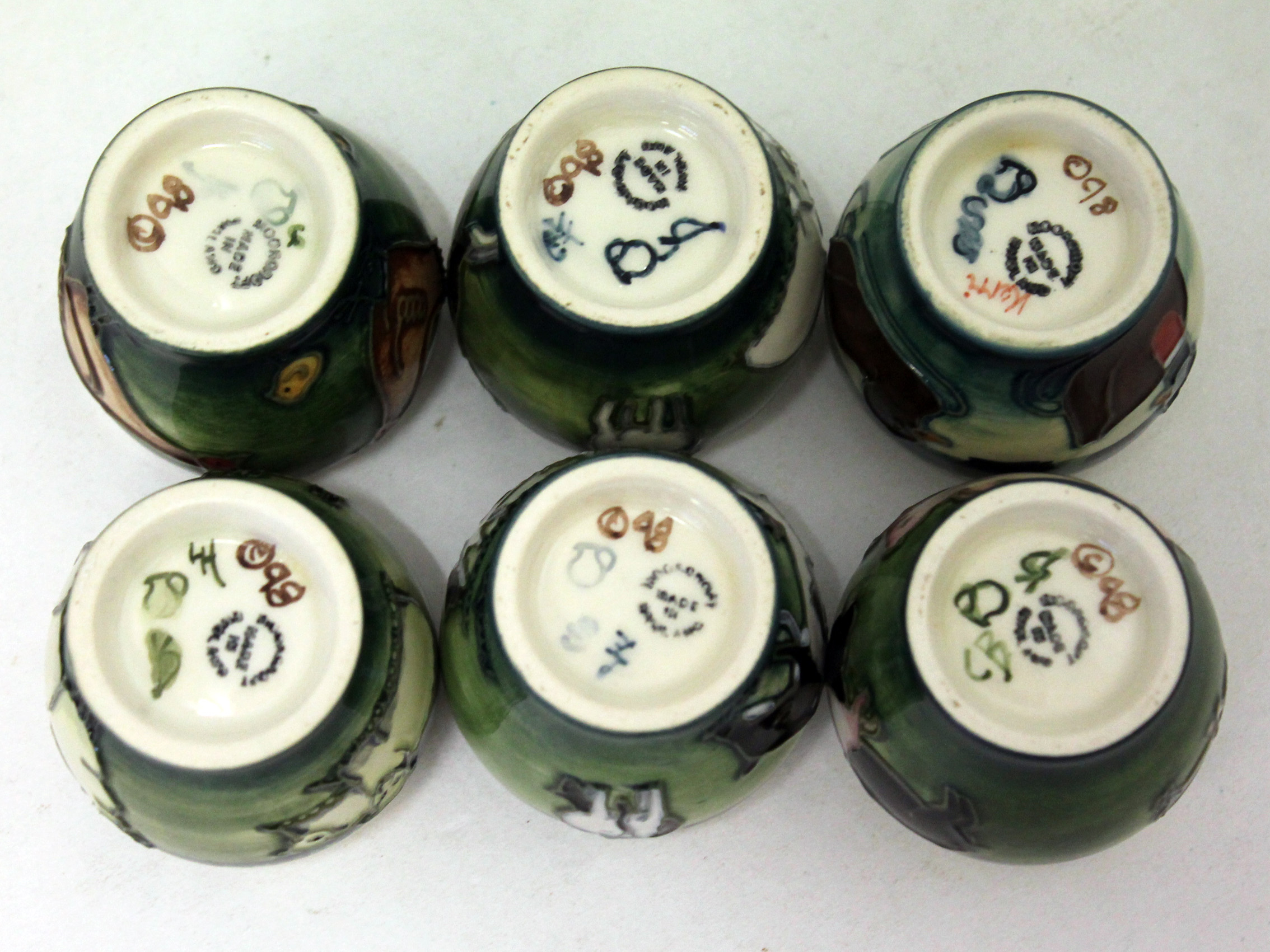 A set of six Moorcroft pottery egg cups each decorated with farm yard ...