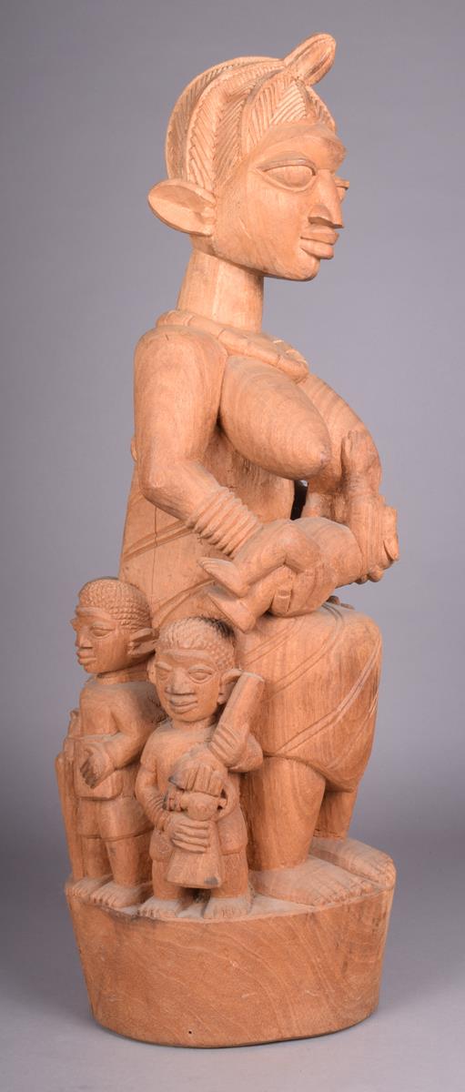 A Yoruba carved maternity figure by Lamidi Olonade Fakeye, with a ...