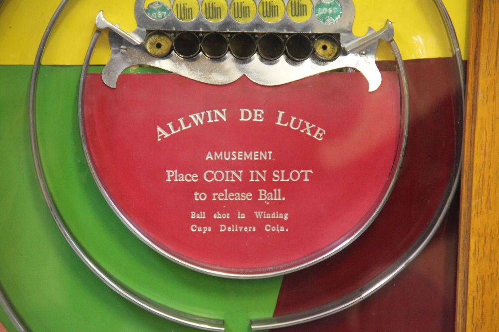 A 1940's Allwin de Luxe arcade penny slot machine, with coloured ...