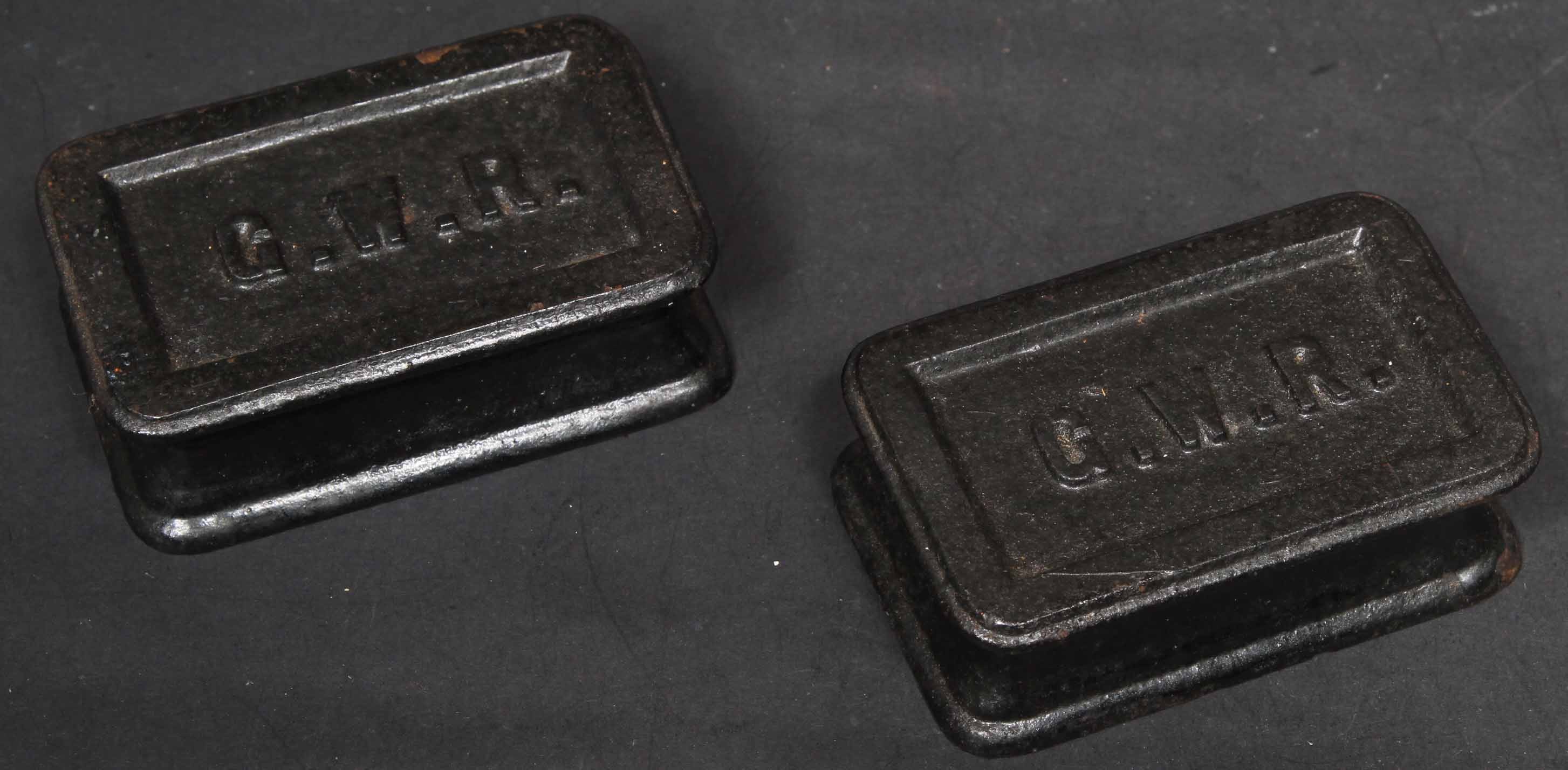 Two GWR cast iron paperweights.