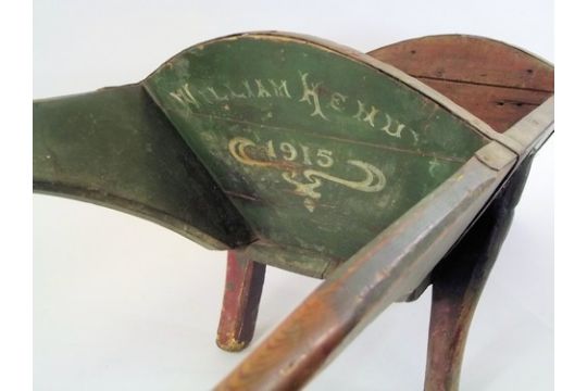 CHILD'S WHEELBARROW. An early 20th century metal bound wooden ...