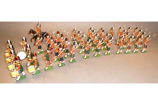 Highlanders marching at the slope eight Black Watch with piper, drummer ...