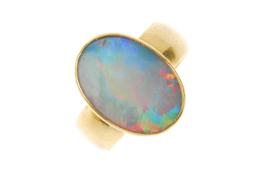 A late Victorian 22ct gold opal doublet ring. The oval opal doublet ...