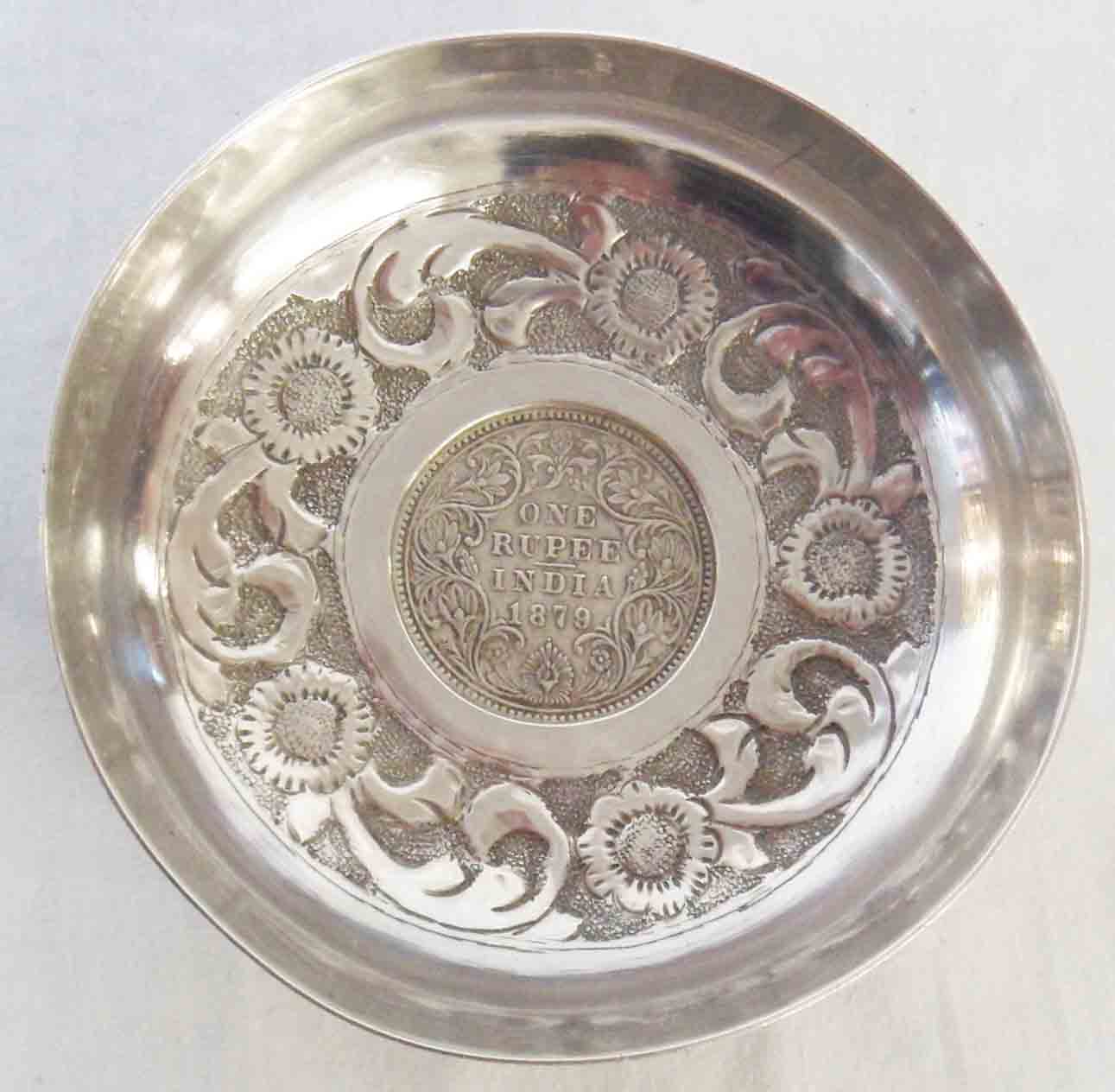 A 3 1/4" diameter marked silver dish, set with an Indian 1879 one rupee ...
