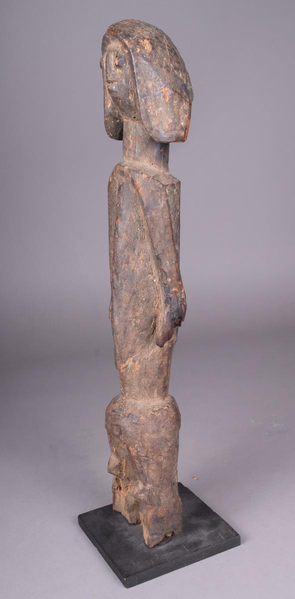 A Mumuye figure Nigeria with a shallow crested coiffure with incised ...
