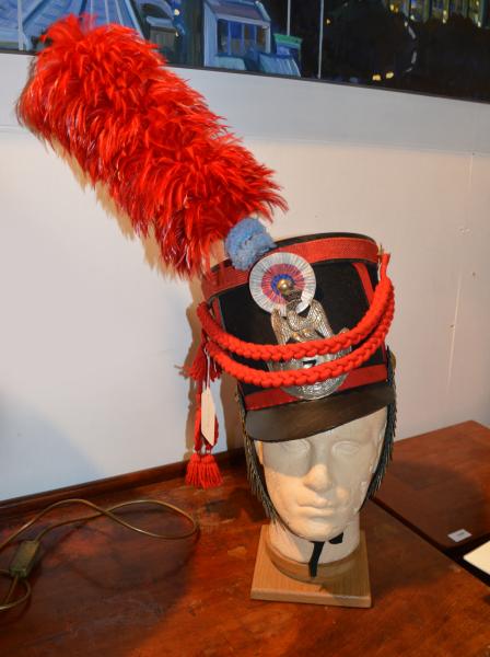 A reproduction French shako or helmet with red feather plume and cap ...