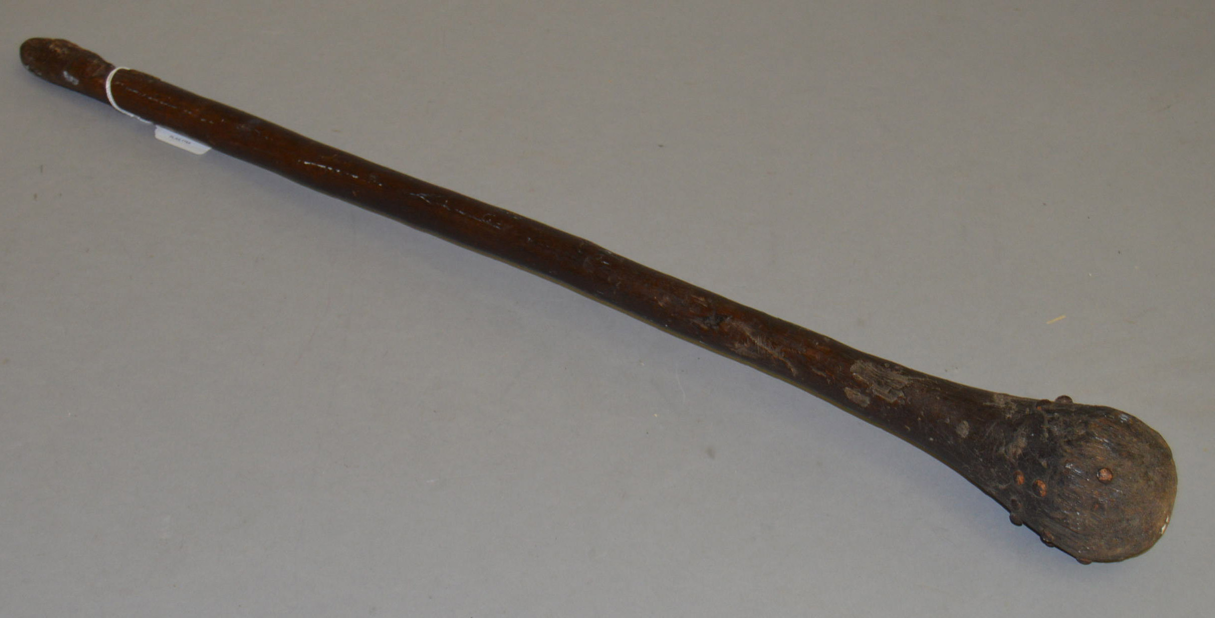 A studded wooden club, possibly a WW1 trench club. 80cm long with 5 ...
