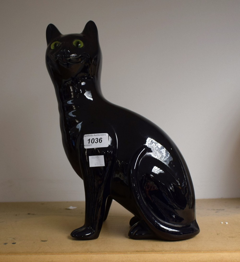 A large Bretby Art Pottery glass eyed black cat, a/f