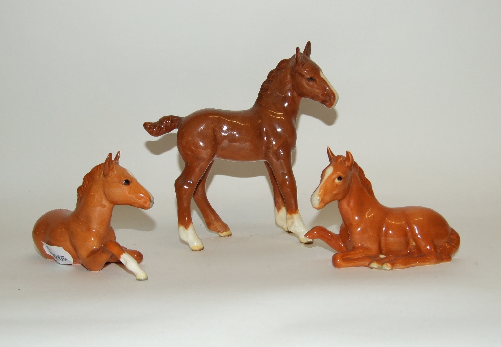 A Beswick Foal, lying, chestnut, 915, another (leg glued), and a Shire ...