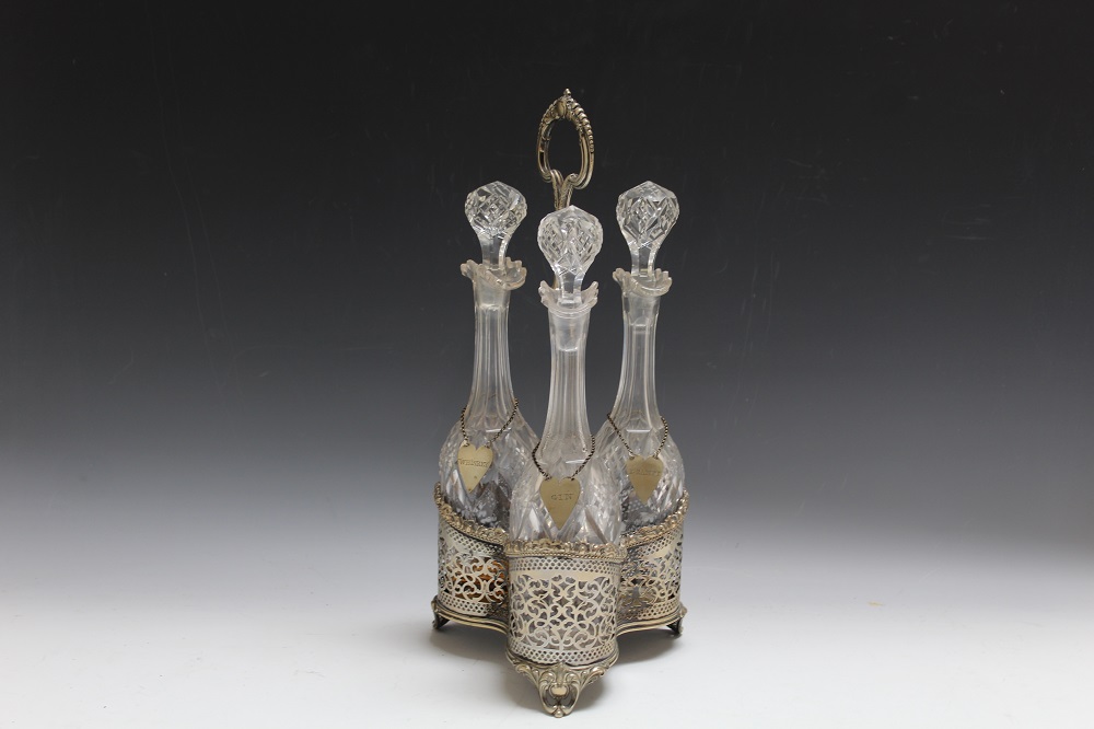 A TALL THREE BOTTLE TREFOIL DECANTER STAND AND BOTTLES, the stand ...
