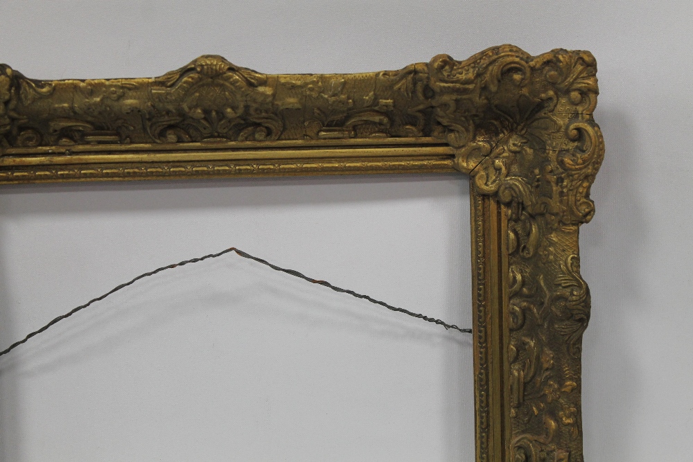 A DECORATIVE GILT ANTIQUE PICTURE FRAME 42cm X 52cm EXTERNAL AND 30cm X ...