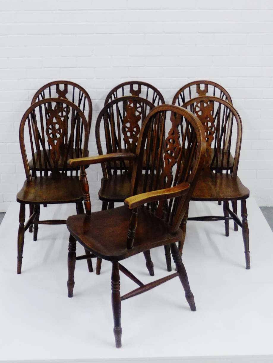 A set of six Ercol style wheel back dark oak chairs together with a ...