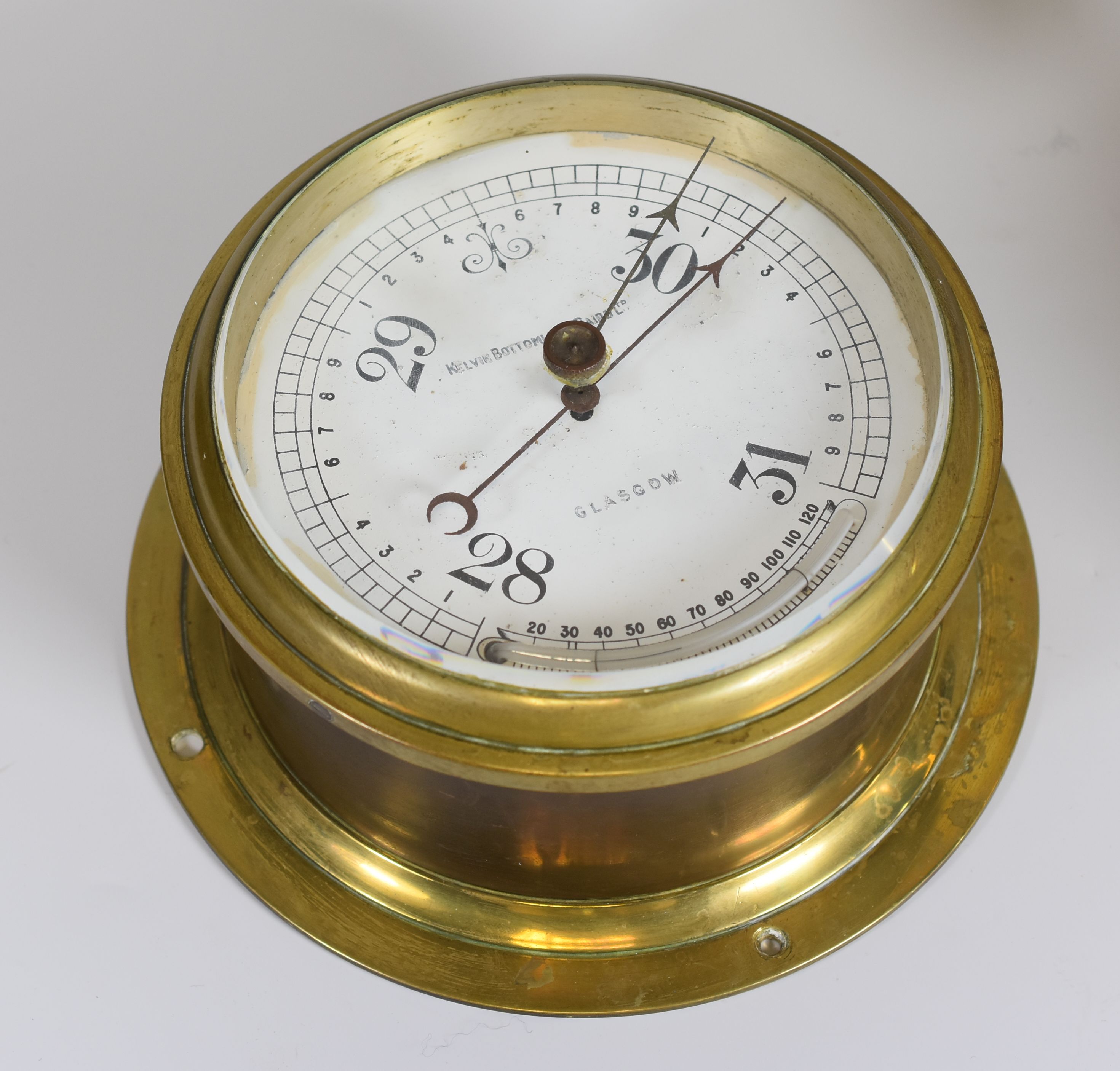 A MARINE BULKHEAD BAROMETER inscribed Kelvin Bottomley & Baird Ltd ...
