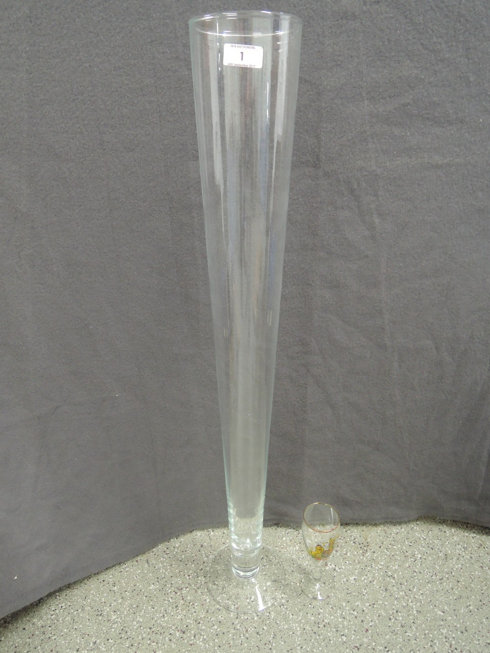 Three tall slender glass vases two 100cm tall and one 80cm