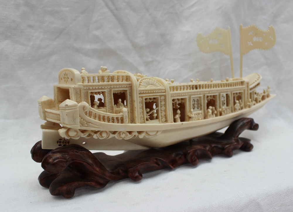 An early 20th century Chinese carved ivory boat, profusely carved with ...