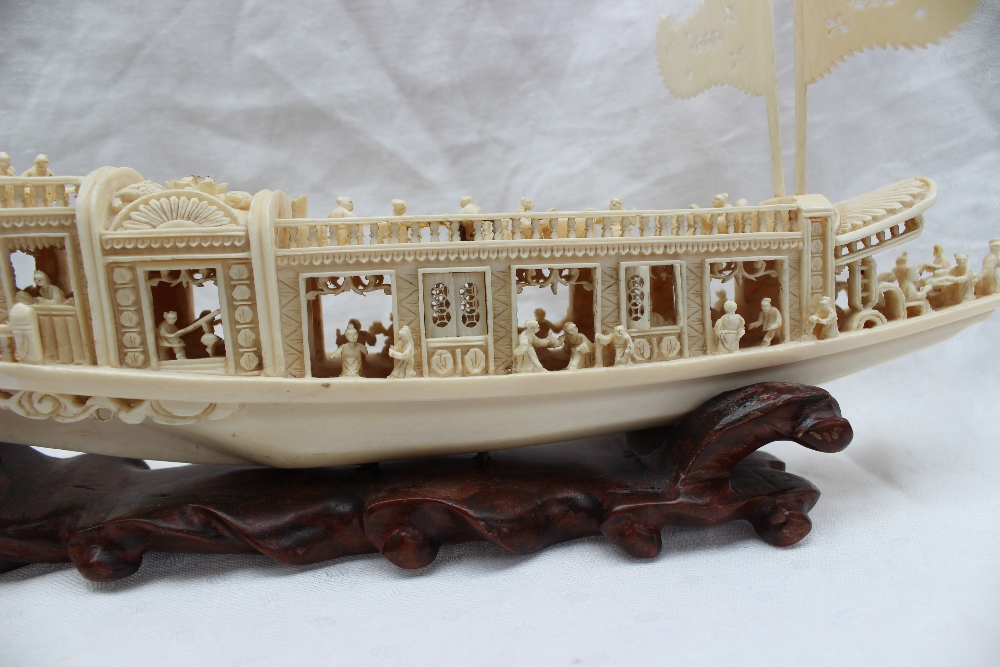 An early 20th century Chinese carved ivory boat, profusely carved with ...