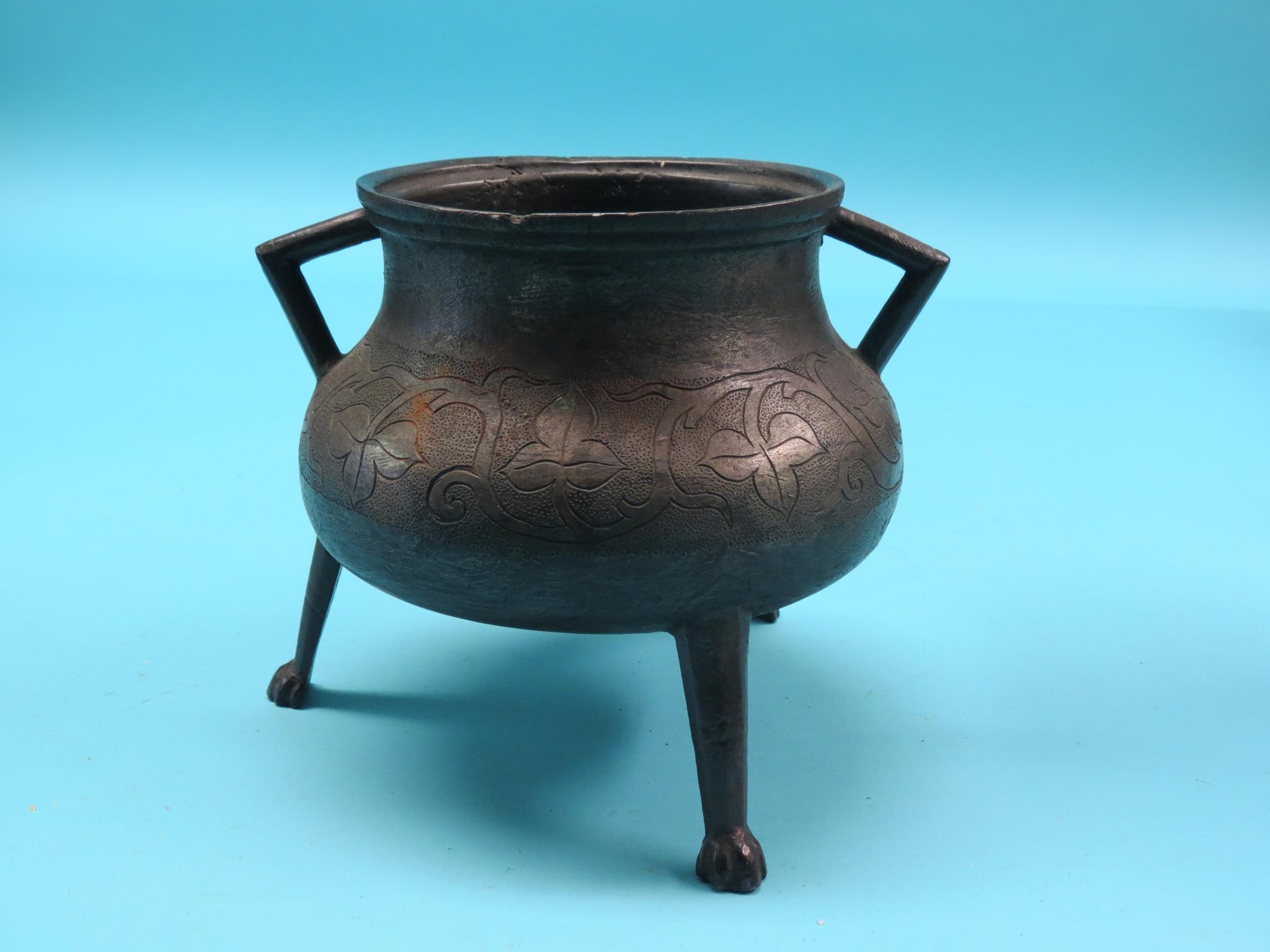 A 17th/18th century bronze cooking pot, twin-handled bulbous form ...