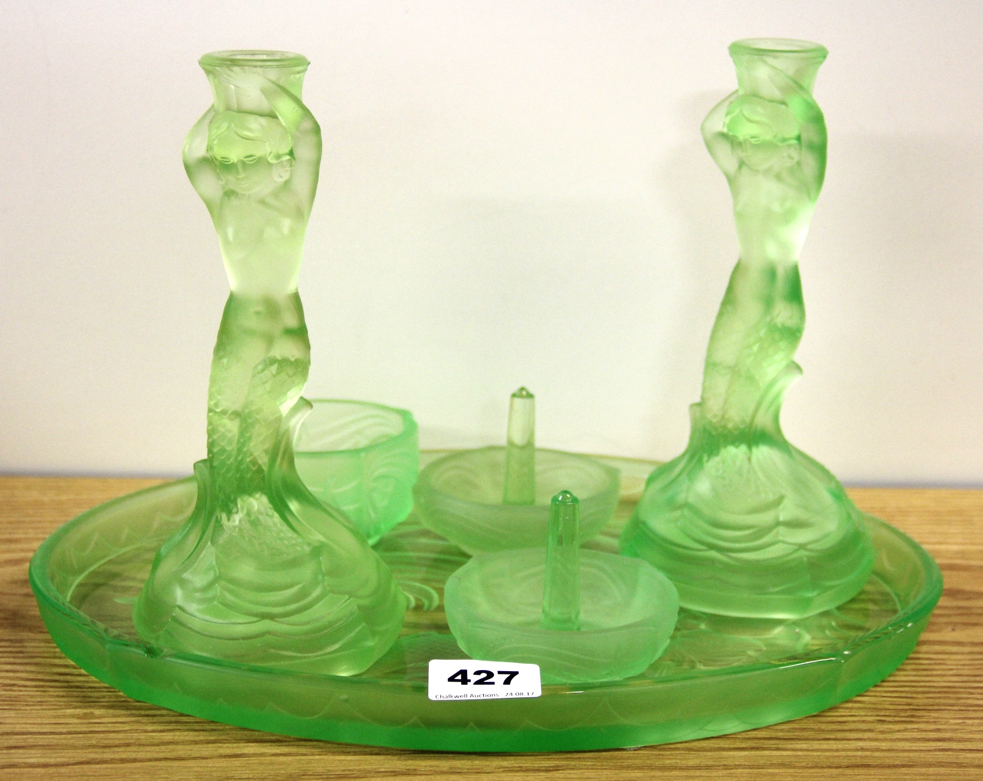 An Art Deco green glass dressing table set.