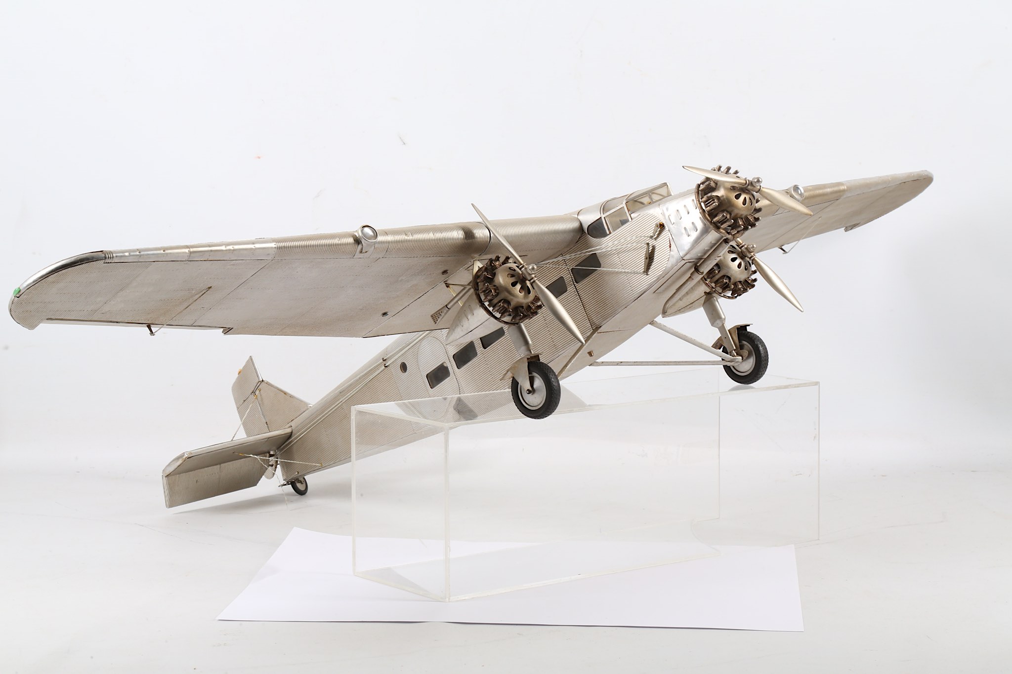An aluminium scale model of a vintage, three propeller passenger ...