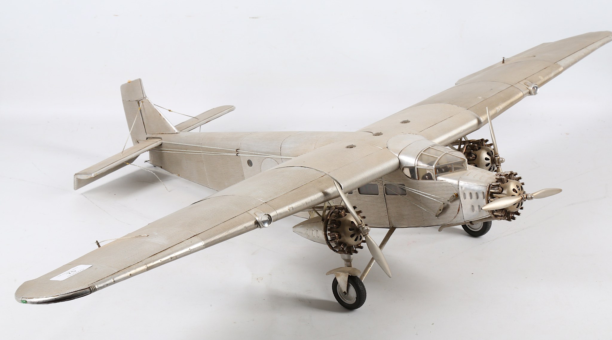An aluminium scale model of a vintage, three propeller passenger ...