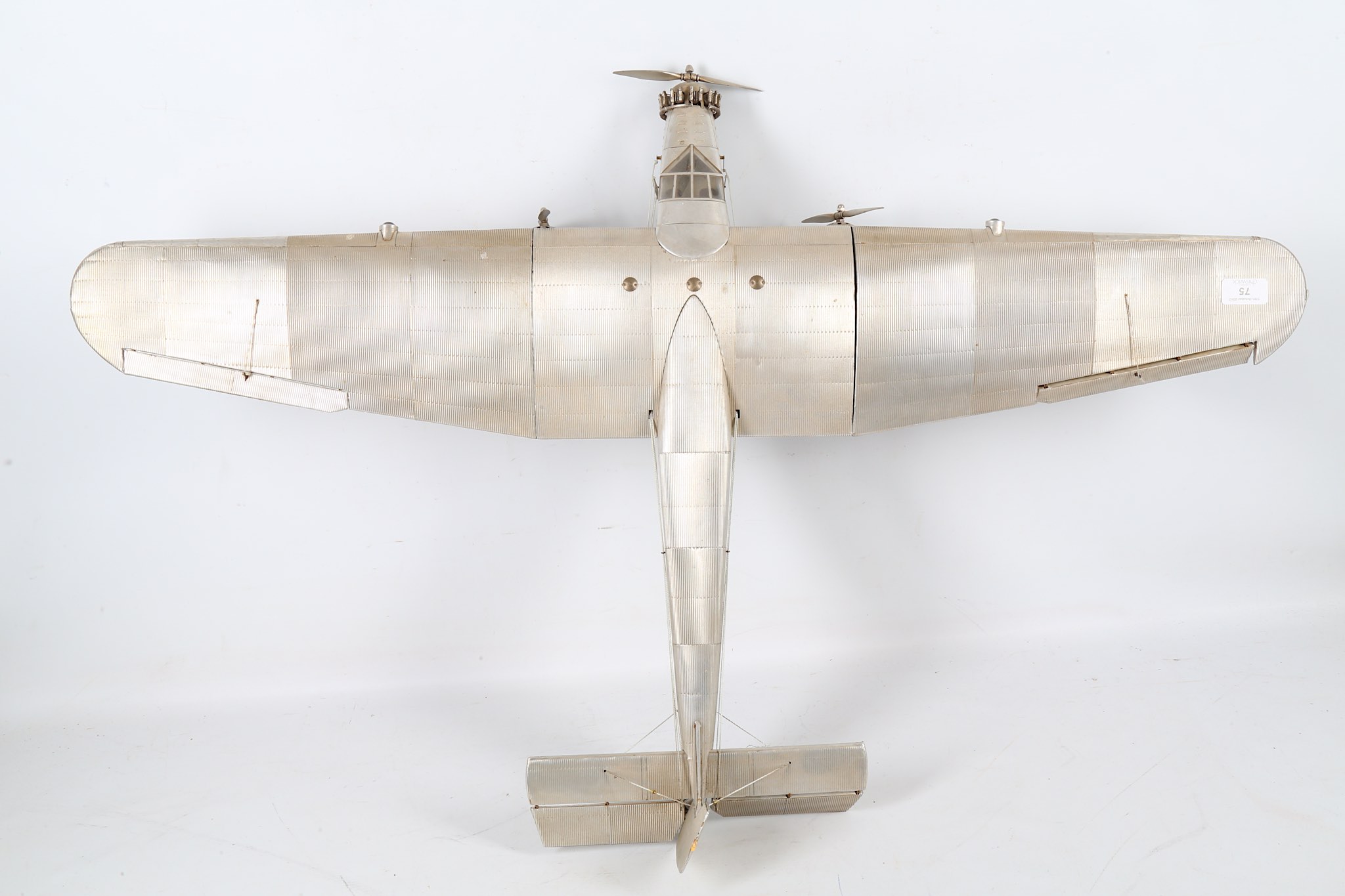 An aluminium scale model of a vintage, three propeller passenger ...