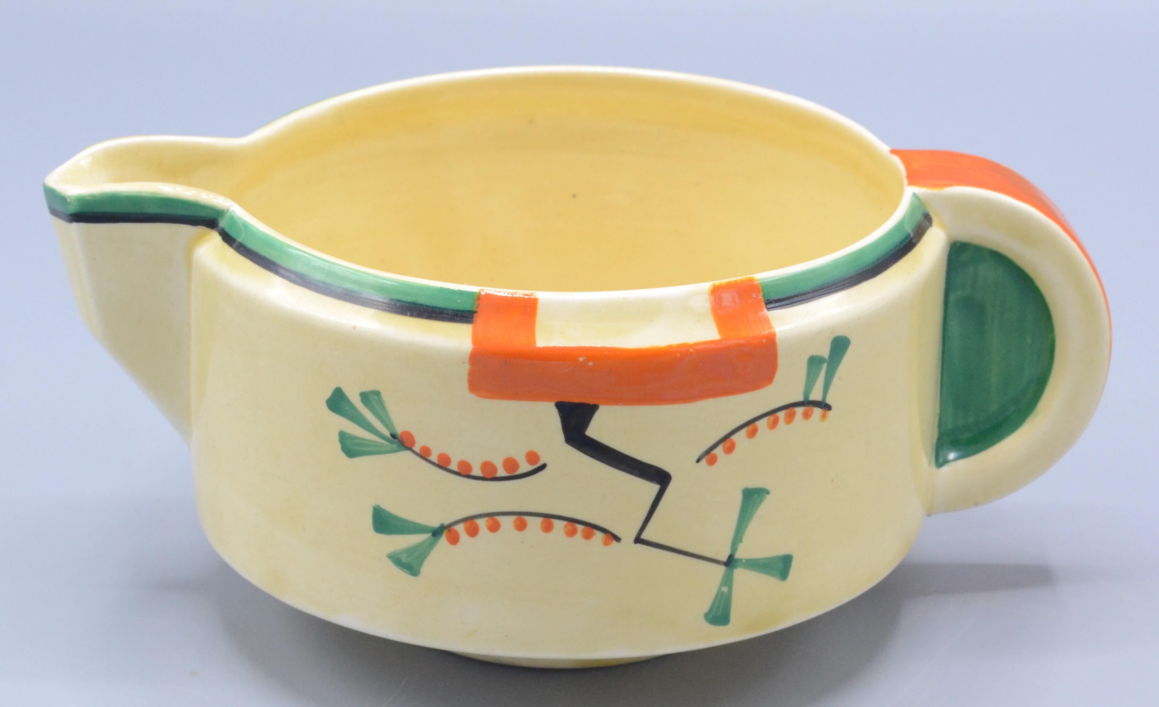 A Clarice Cliff Bizarre Ravel pattern cream jug, with abstract designs ...