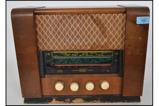 A vintage 20th century 1940's wooden cased valve radio. The glass dial ...