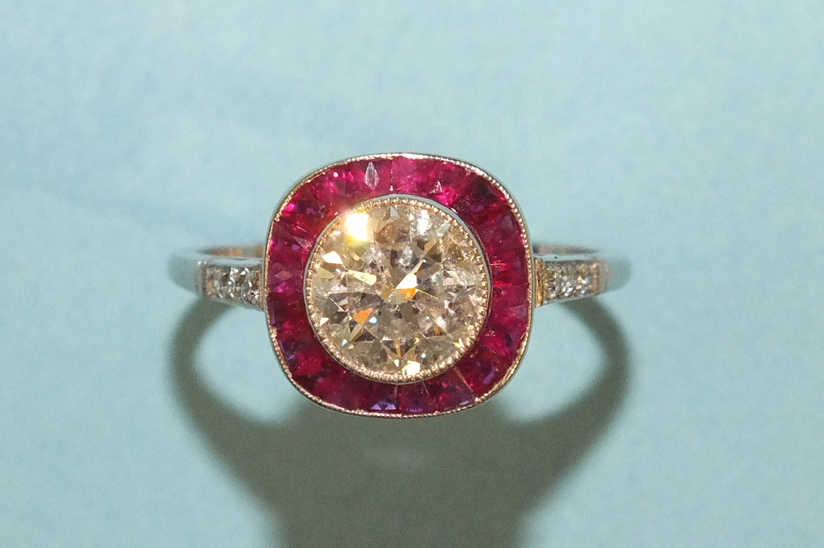 A diamond and ruby cluster ring millegrain-set a brilliant-cut diamond ...