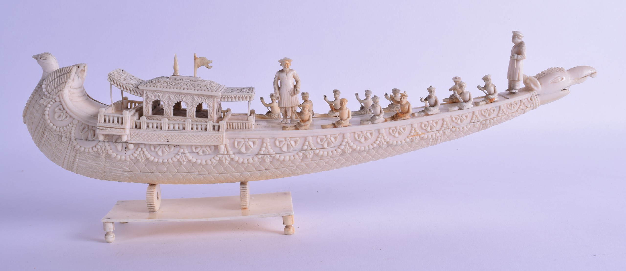 A LARGE 19TH CENTURY INDIAN CARVED IVORY BOAT modelled with various ...