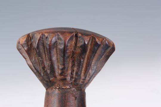 AN ANTIQUE AFRICAN HARDWOOD FIGHTING CLUB with turned shaft and notched ...