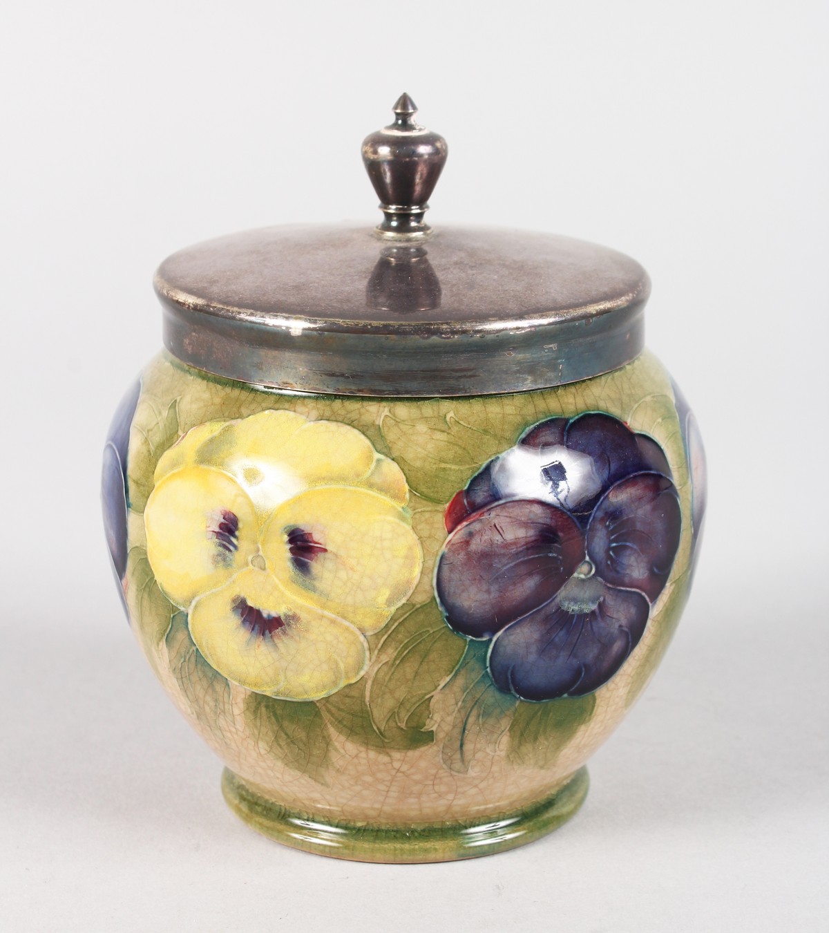 A RARE MOORCROFT MACINTYRE PANSY POTTERY JAM POT AND COVER, CIRCA. 1912 ...