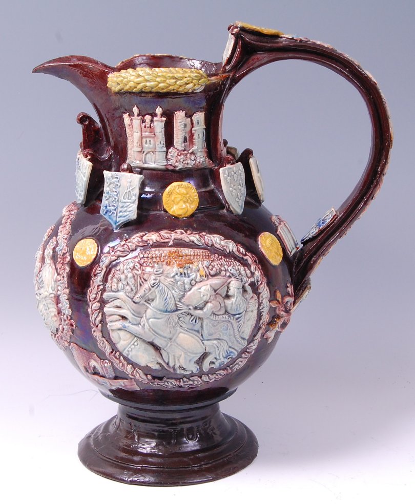 An Edward Bingham for Castle Hedingham pottery Essex jug, on a brown ...