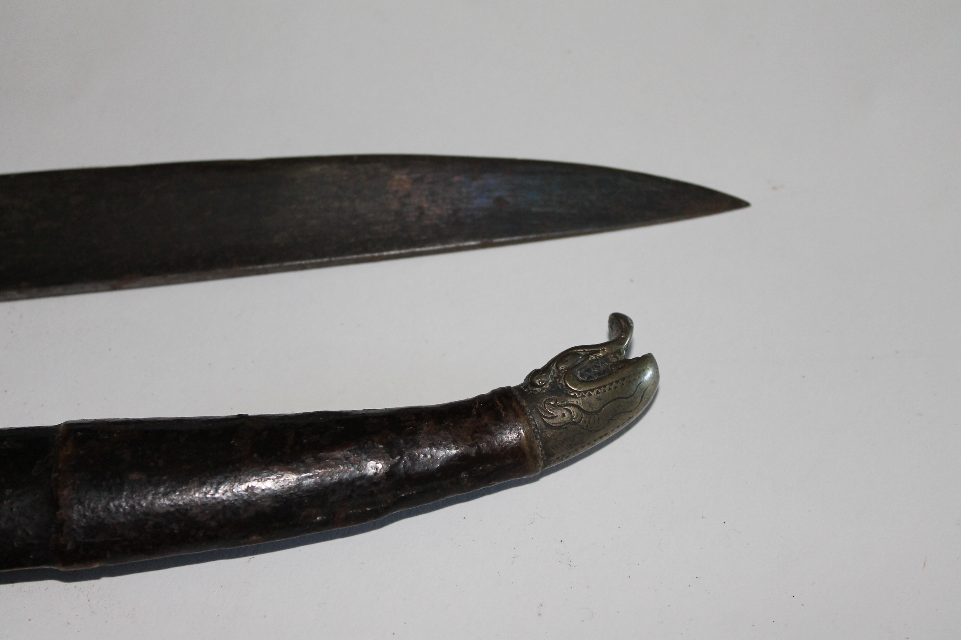 A YATAGAN SWORD. A Turkish Yatagan sword with silver hilt (damaged in ...