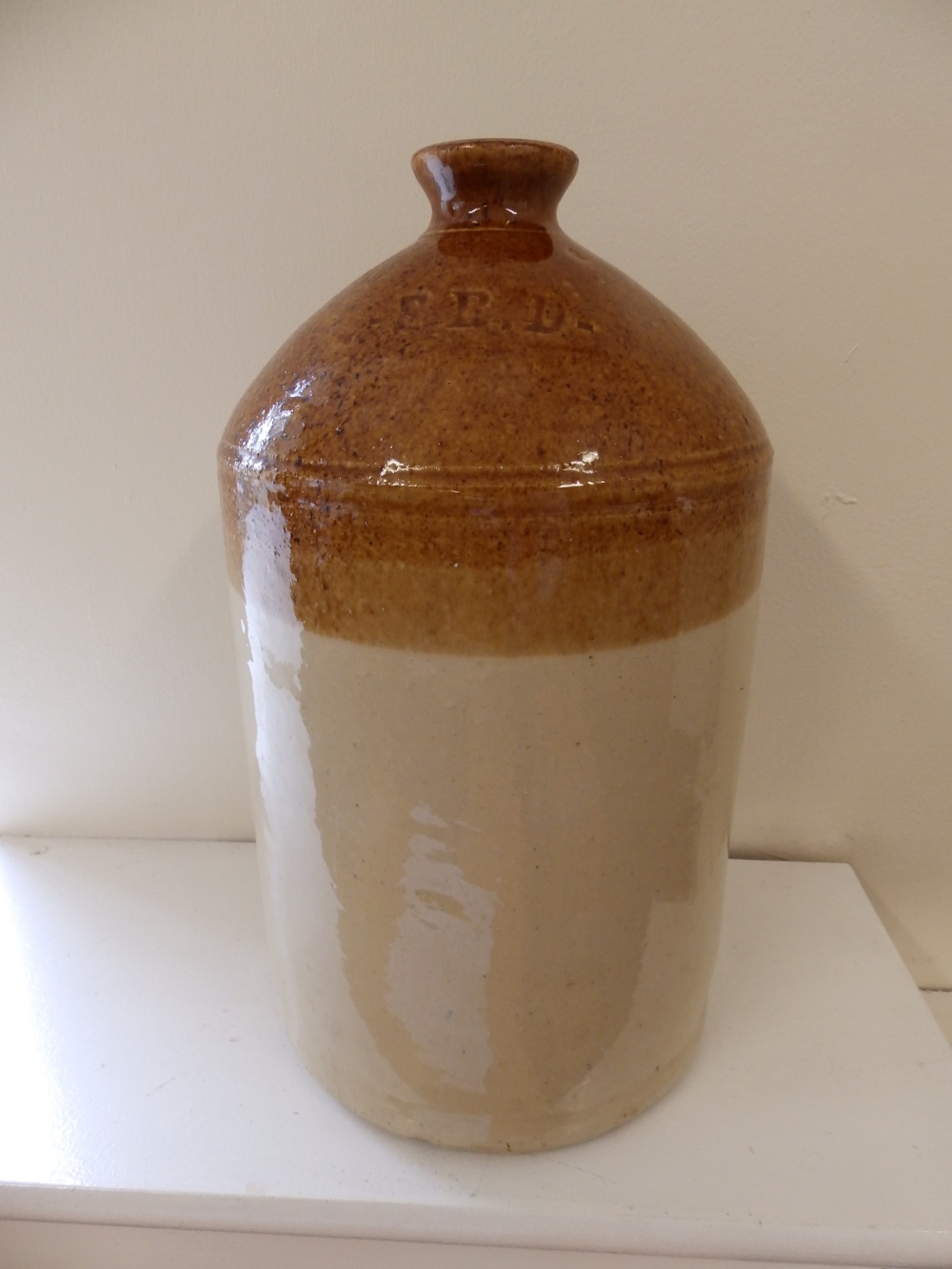 A WWI SRD Fulham Pottery rum jar together with an advertising jar for ...
