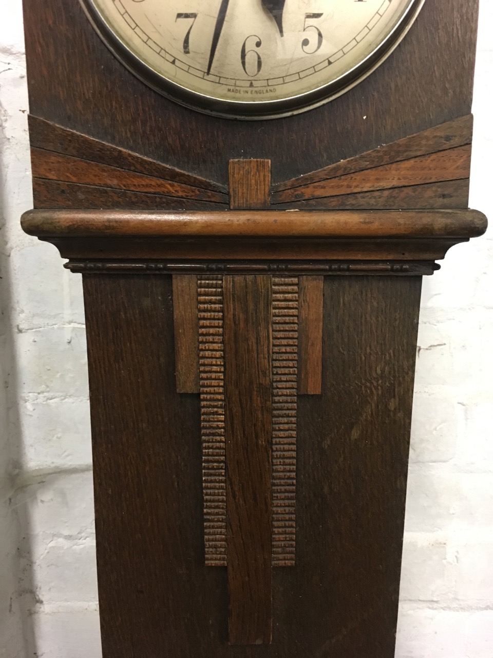 A deco oak cased grandmother clock, the Bravingtons Ltd silvered dial ...