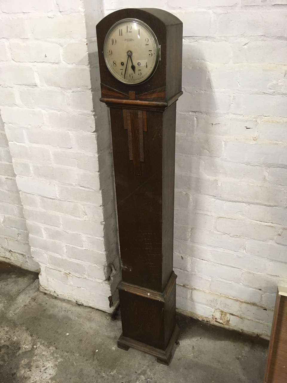 A deco oak cased grandmother clock, the Bravingtons Ltd silvered dial ...